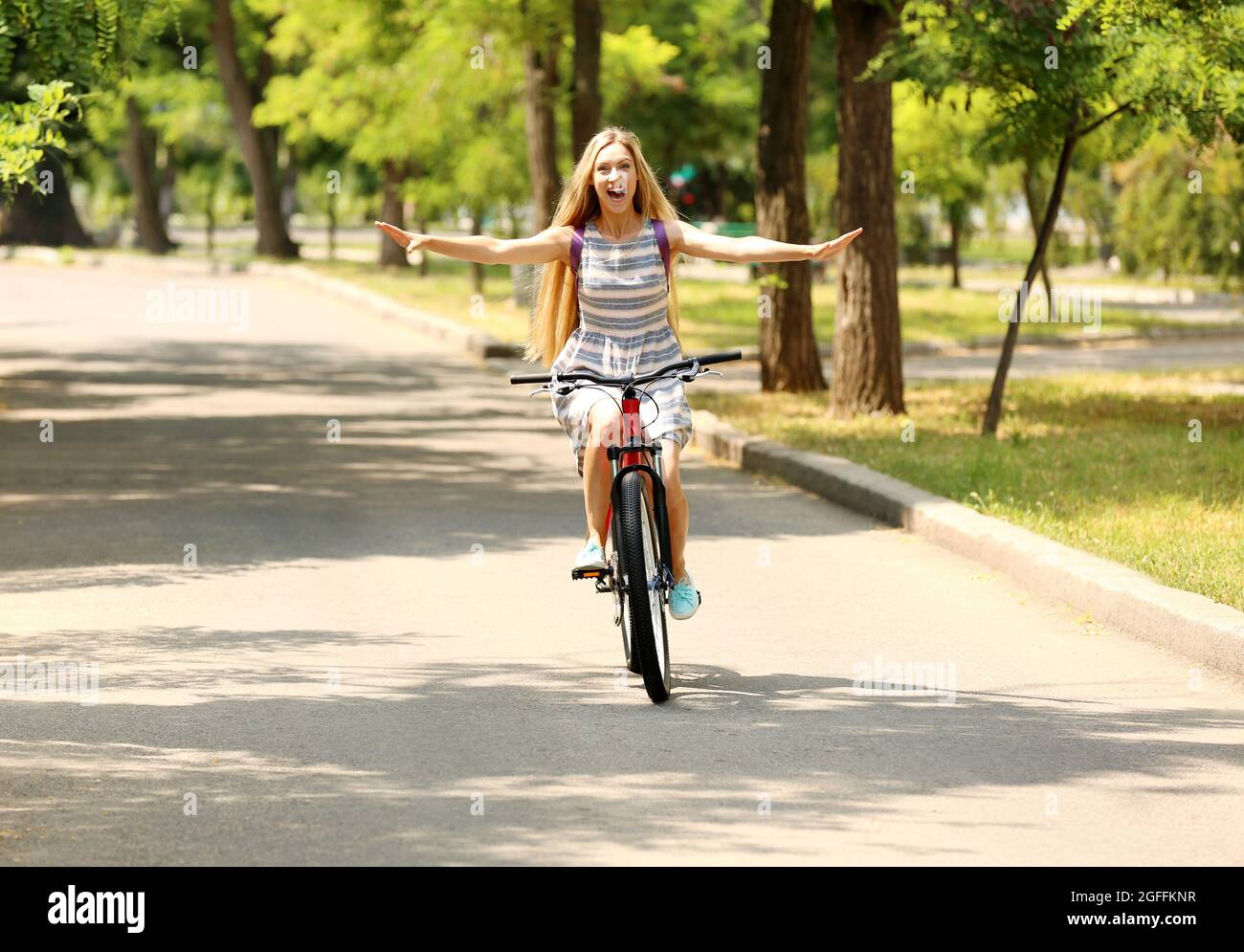 Beautiful girl riding bike on street Stock Photo - Alamy