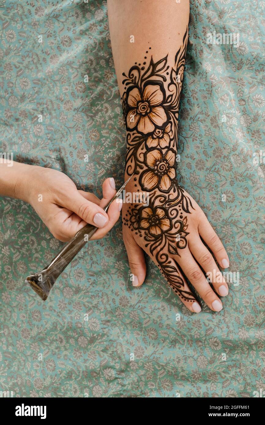Artist applying henna tattoo on women hands. Mehndi is traditional ... Artist applying henna tattoo on women hands. Mehndi is traditional ...