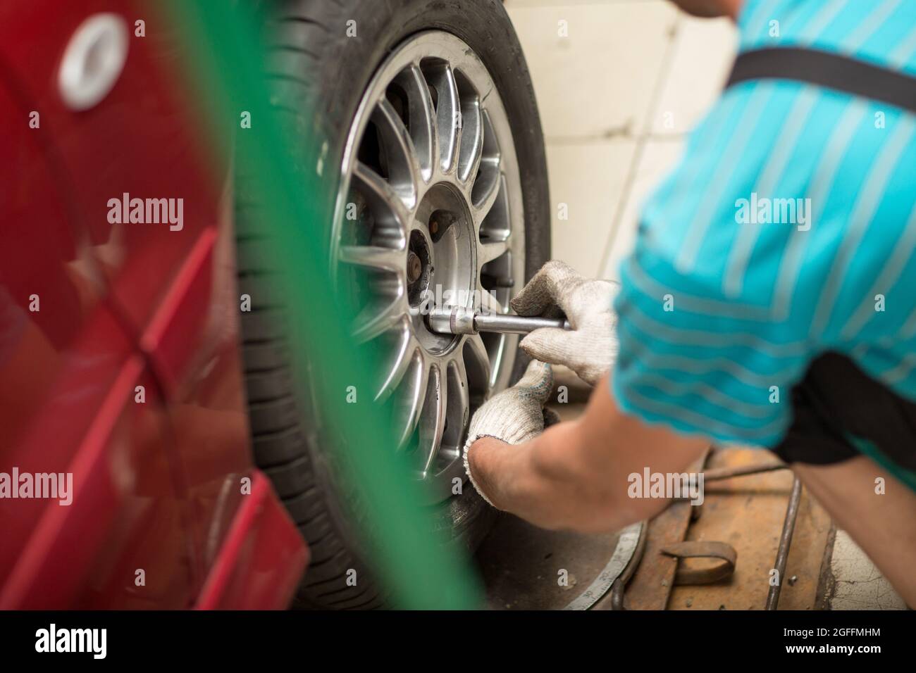 Repair or changing tire car vehicle mechanic screwing car wheel at ...