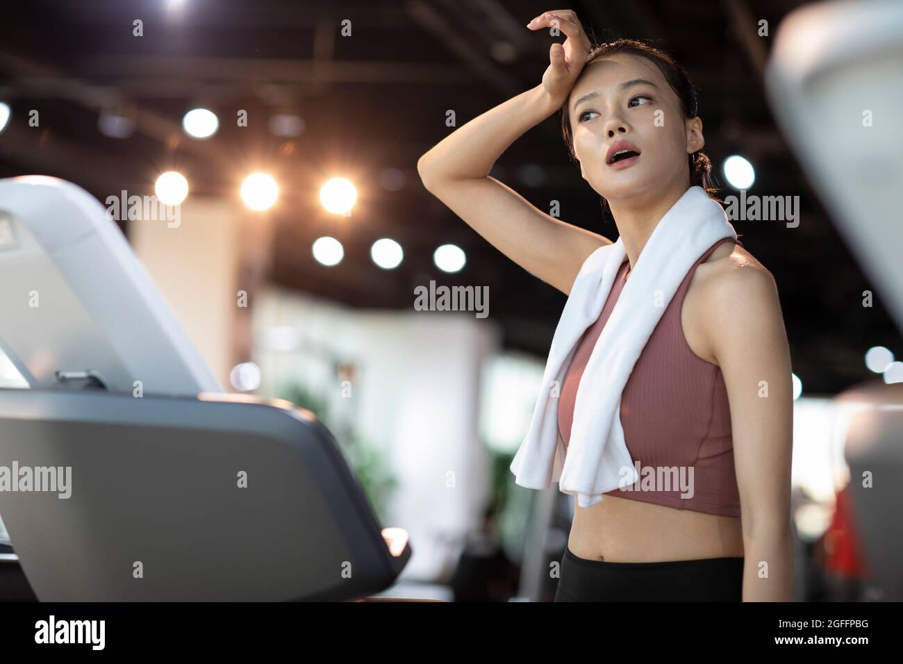 Young woman taking a break from workout at gym Stock Photo - Alamy