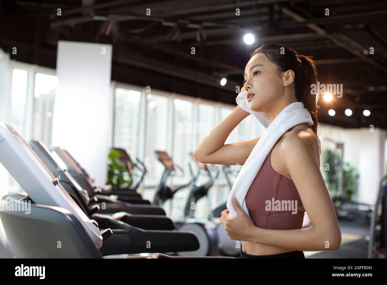 Young woman taking a break from workout at gym Stock Photo - Alamy