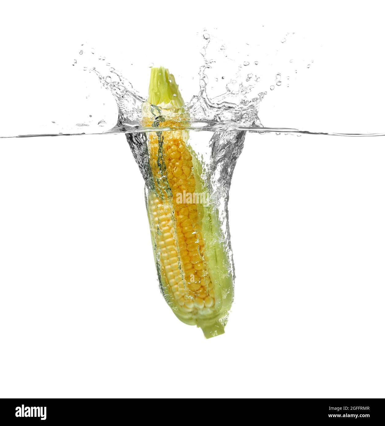 Unpeeled corn falling into water on white background Stock Photo - Alamy