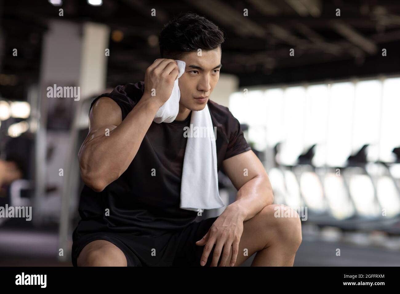 Young man taking a break from workout at gym Stock Photo - Alamy