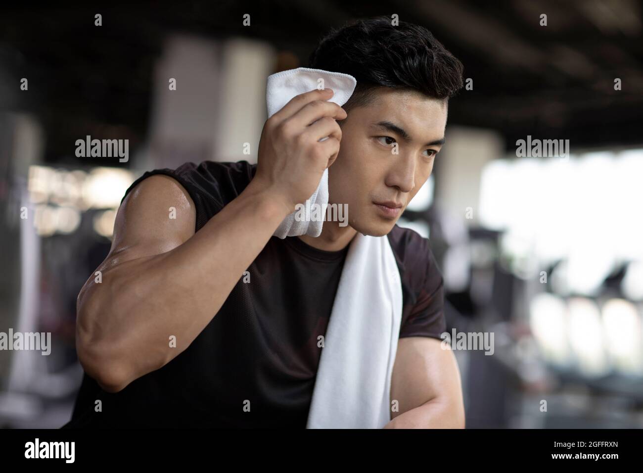 Young man taking a break from workout at gym Stock Photo - Alamy