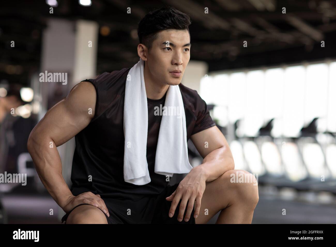 Young man taking a break from workout at gym Stock Photo - Alamy