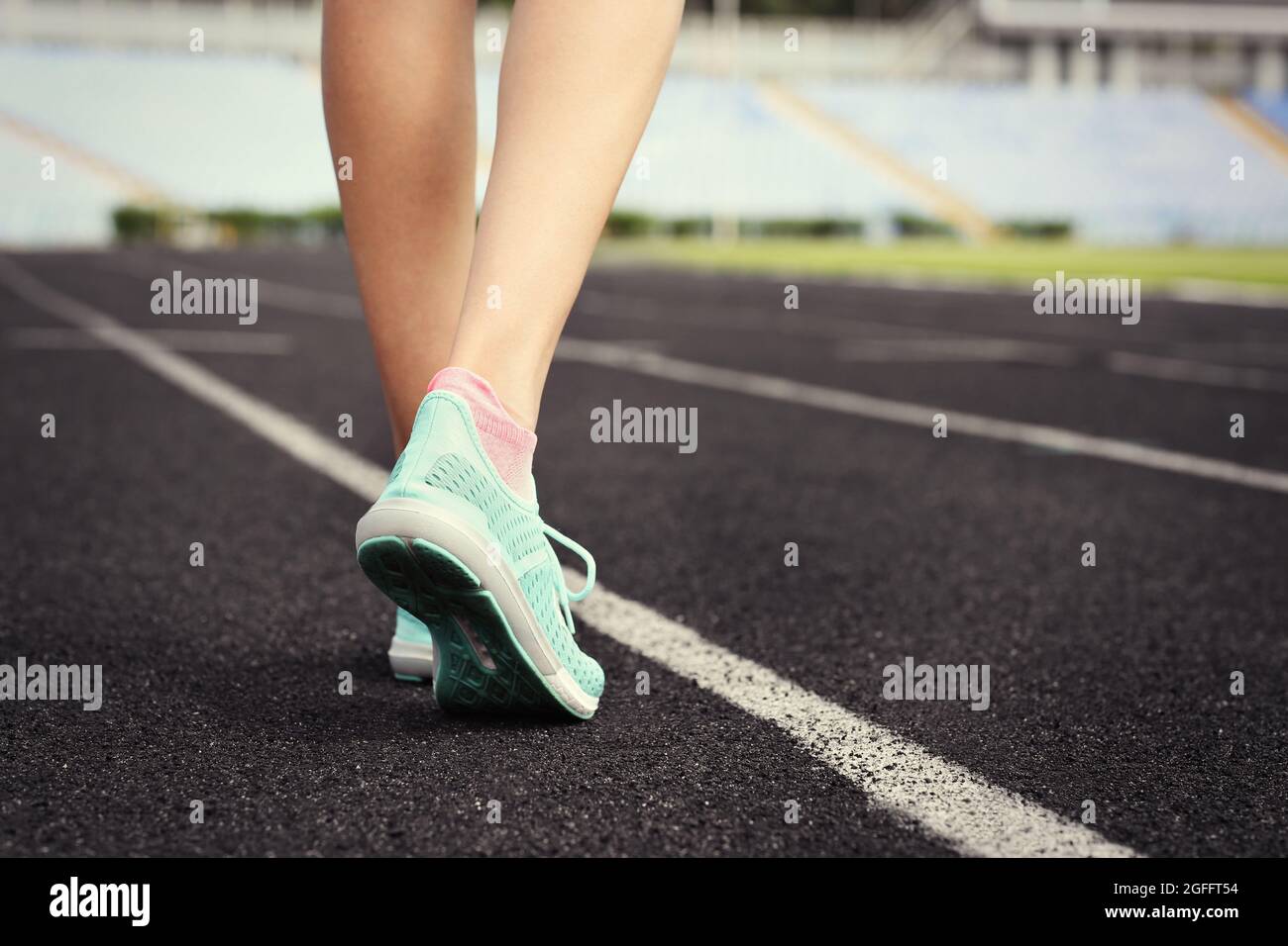 Woman wearing mint sneakers on a running stadium Stock Photo - Alamy