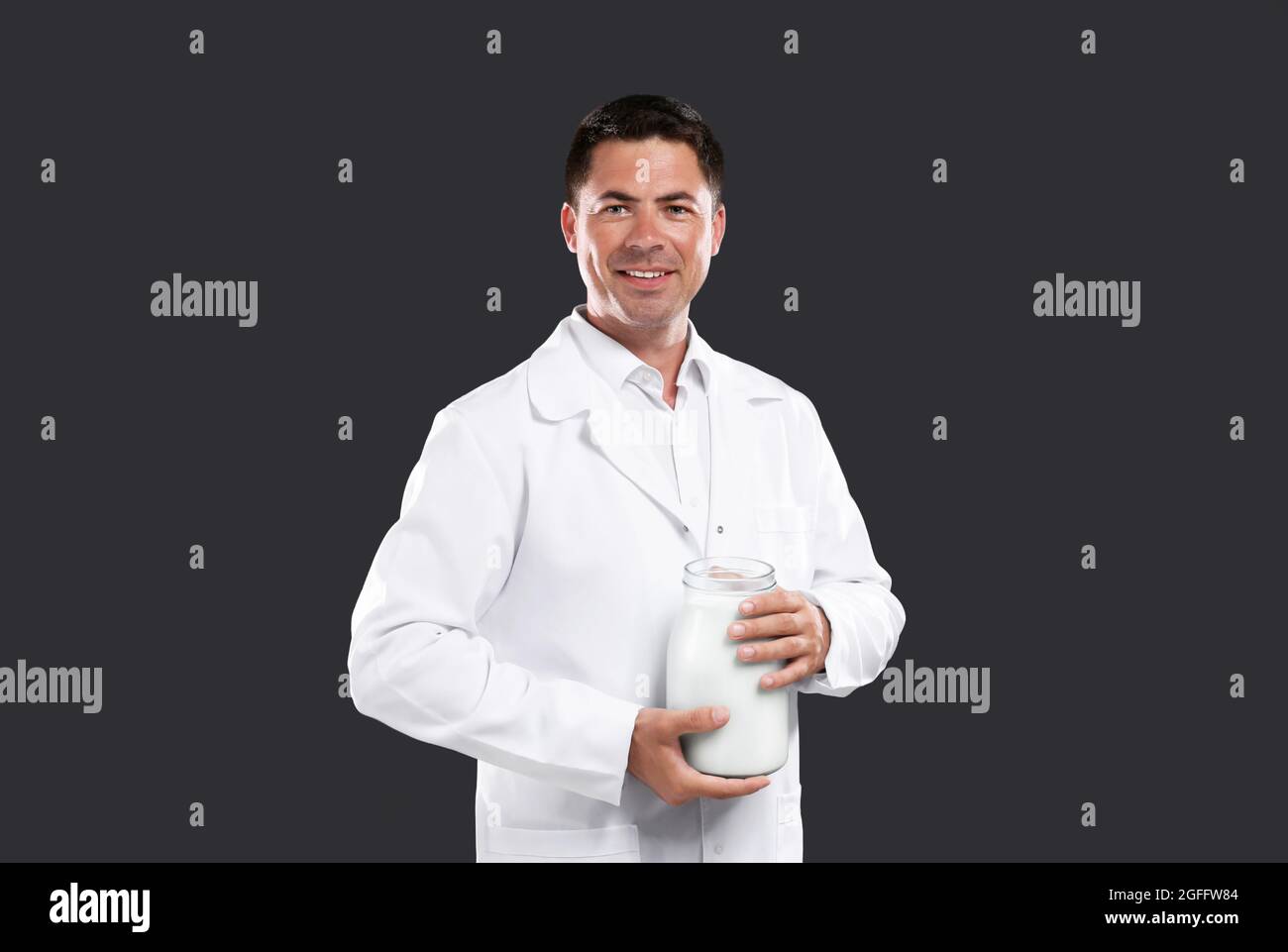 Male milk expert on dark background Stock Photo - Alamy