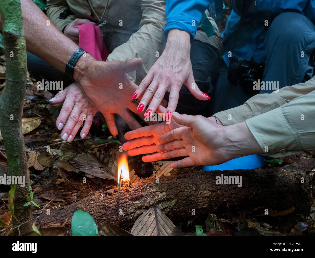 People's hands are warmed by the flame of a fire. Amazonia. Jungle of ...