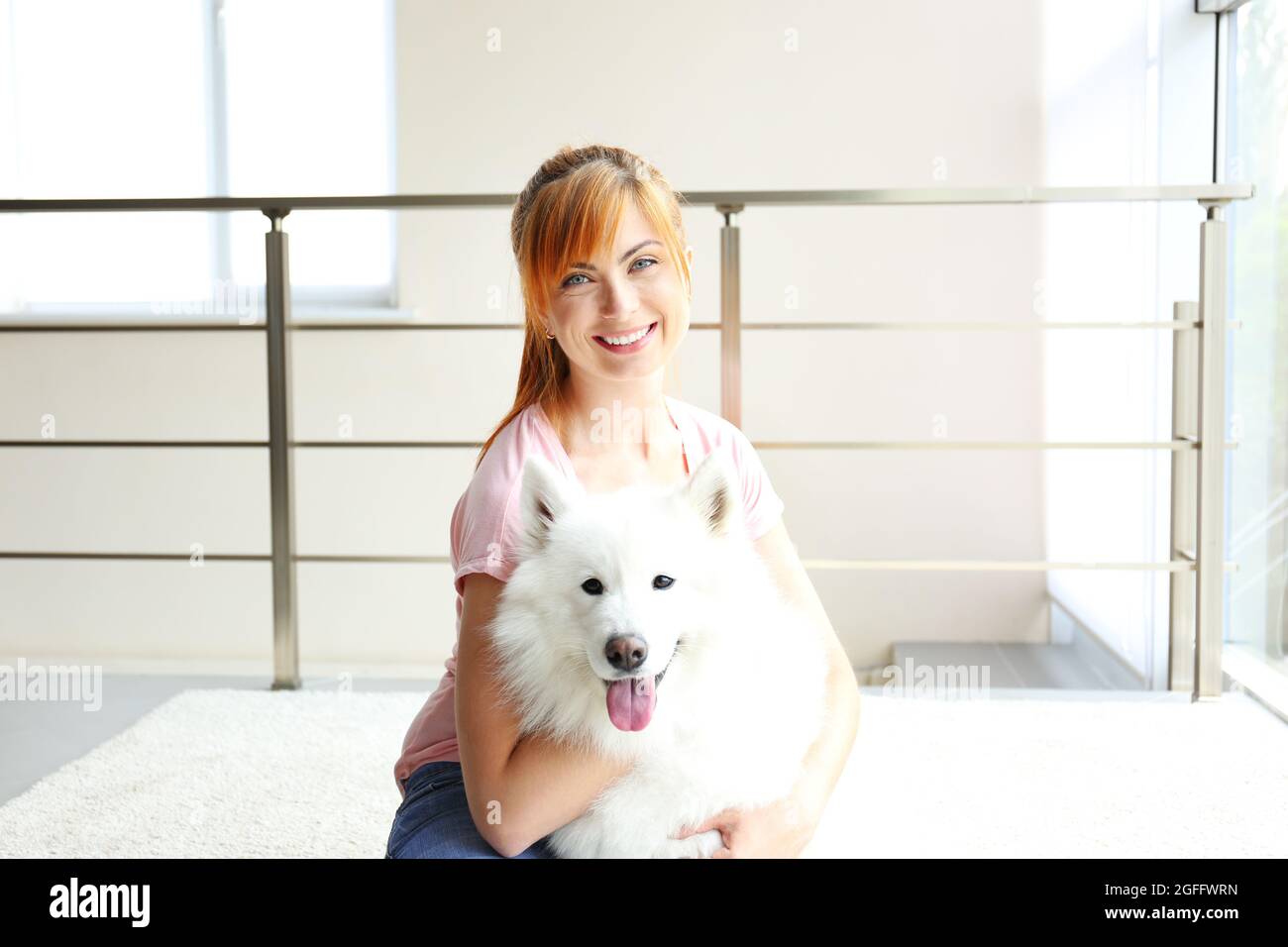Beautiful girl with Samoyed dog Stock Photo - Alamy