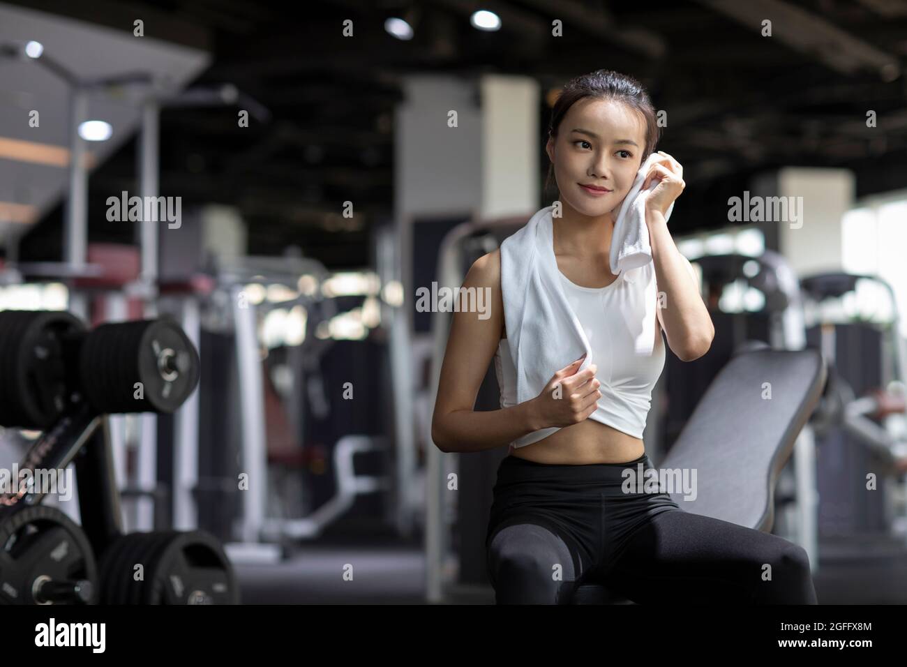 Young woman taking a break from workout at gym Stock Photo - Alamy
