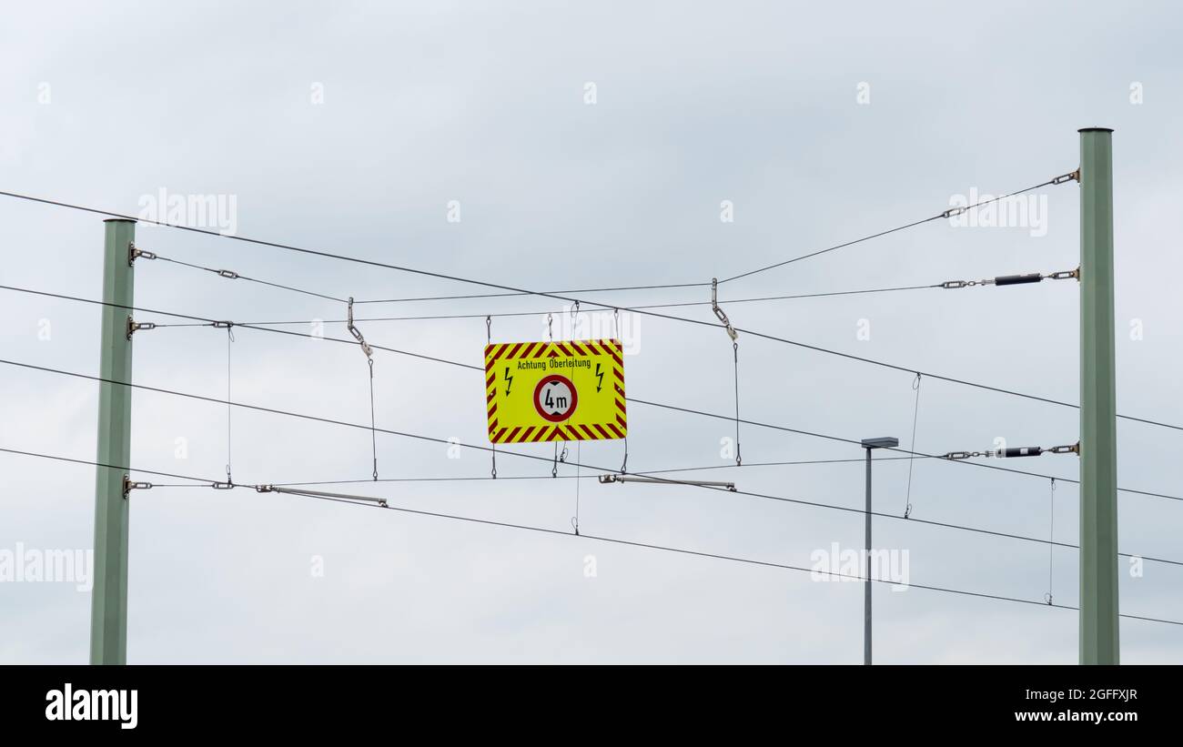 Warning sign for high voltage on an overhead line Stock Photo - Alamy