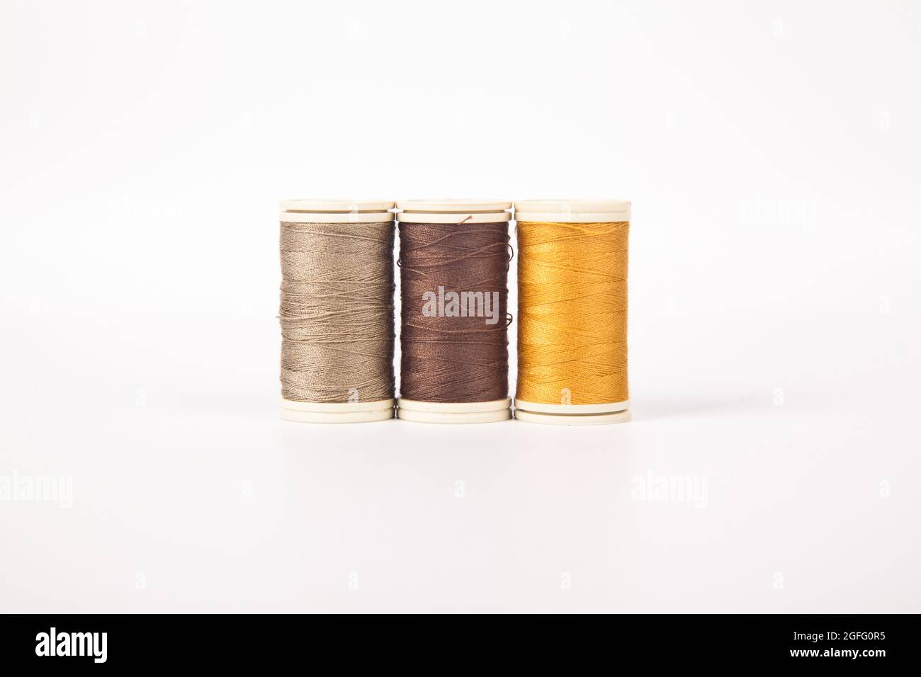 Spools and bobbins of thread for sewing in different colors, isolated ...