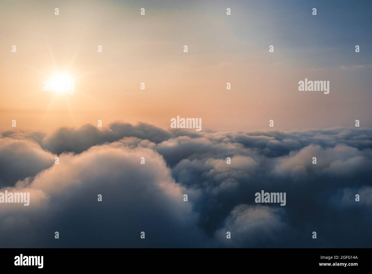 The sun shines over a layer of thick cold fog. Fog hangs over cold ...