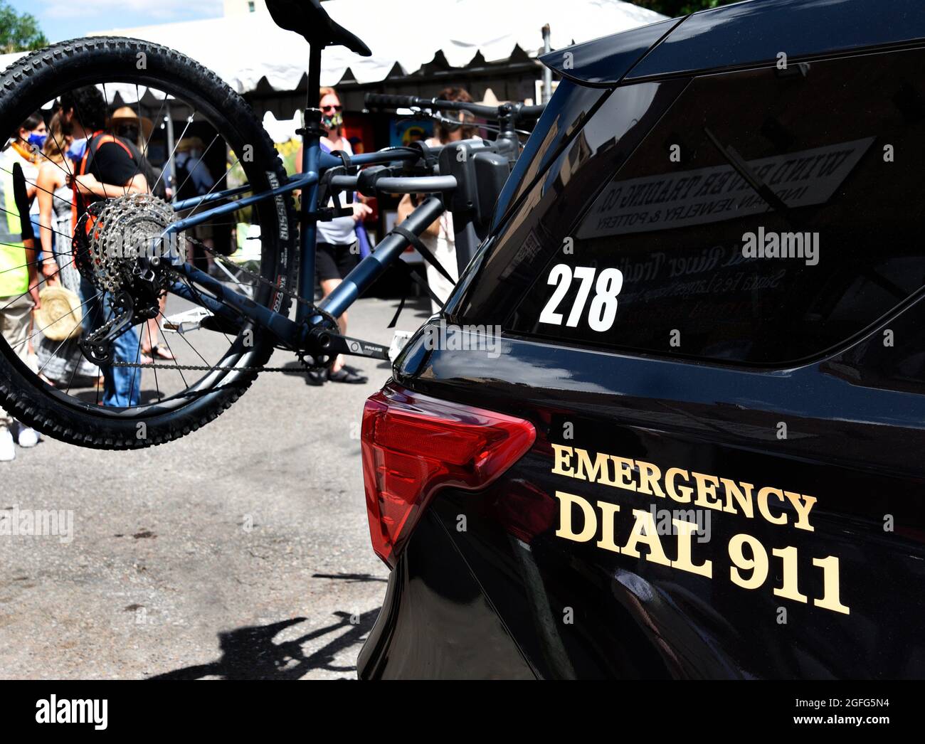 A police car with Emergency Dial 911 parked at an outdoor art show in ...