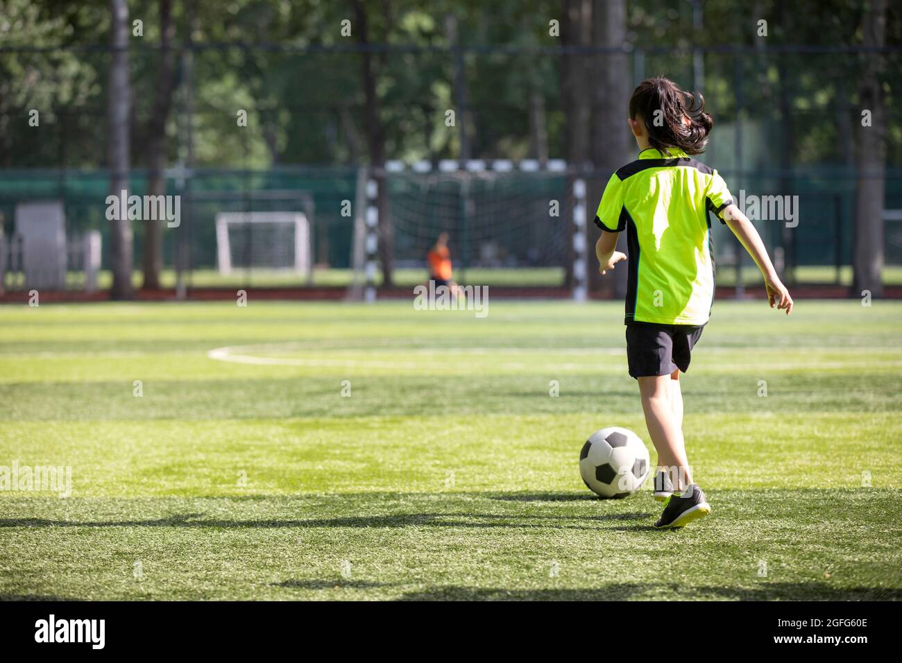 Children playing football on field Stock Photo - Alamy