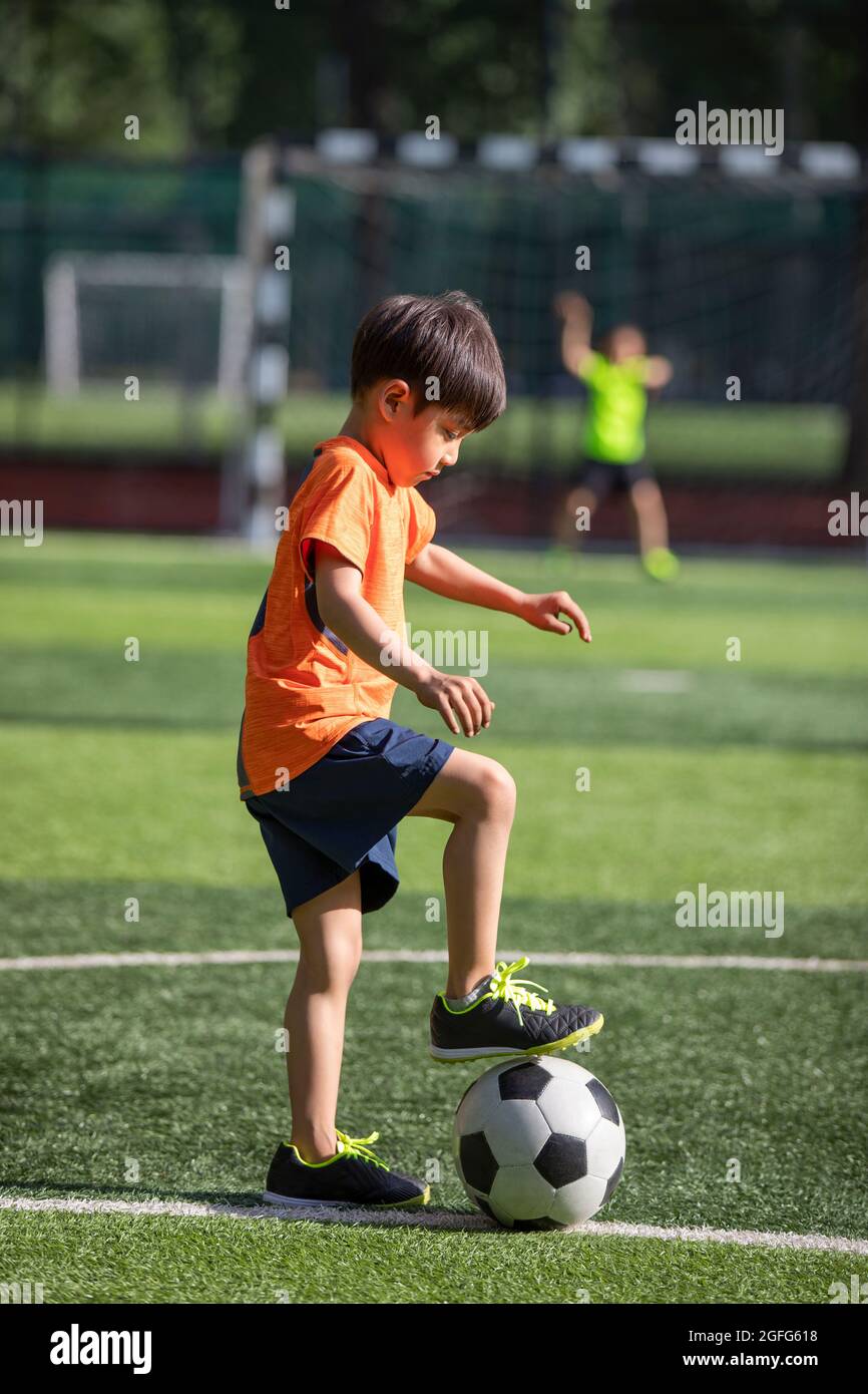 Asian children playing football hi-res stock photography and images - Alamy