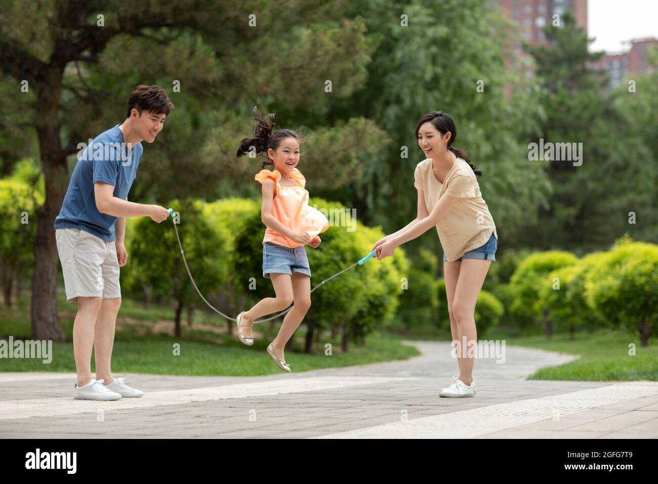 Three girls playing jump rope hi-res stock photography and images - Alamy