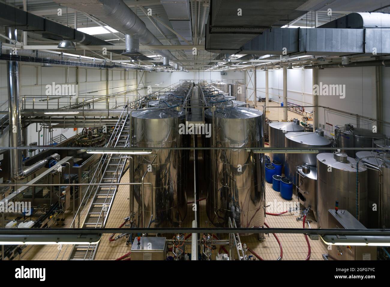 Modern winery production line. Storage vats and bottling equipment ...