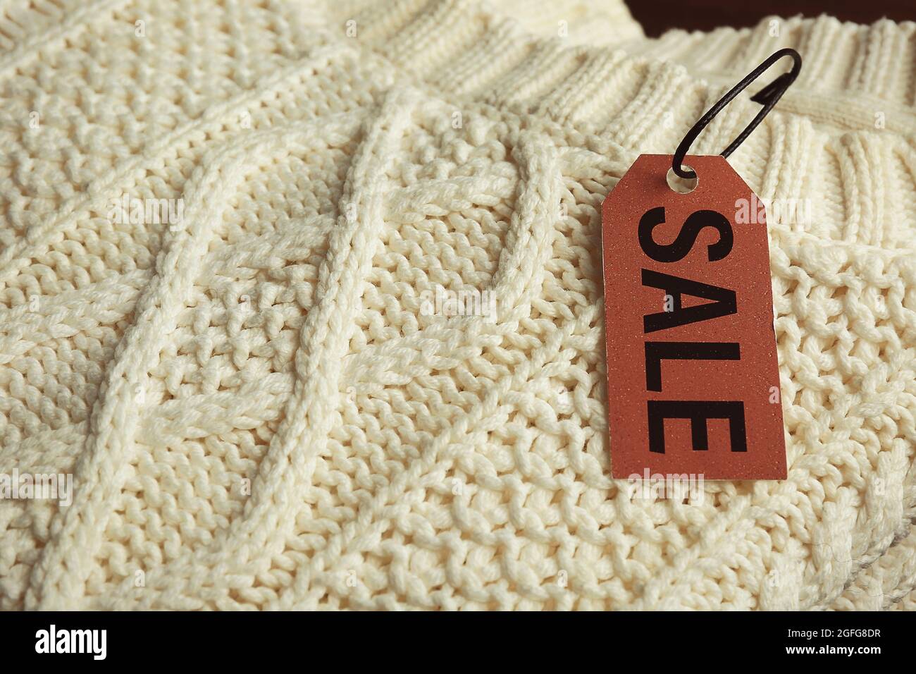 Sale label on sweater, closeup Stock Photo - Alamy