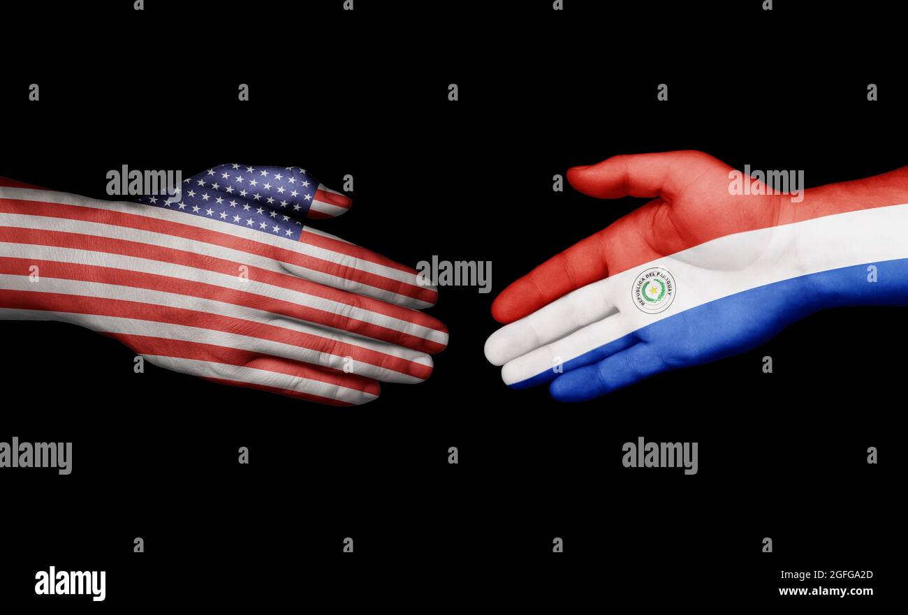 Country handshaking concept, hands with USA and Paraguay flags ...