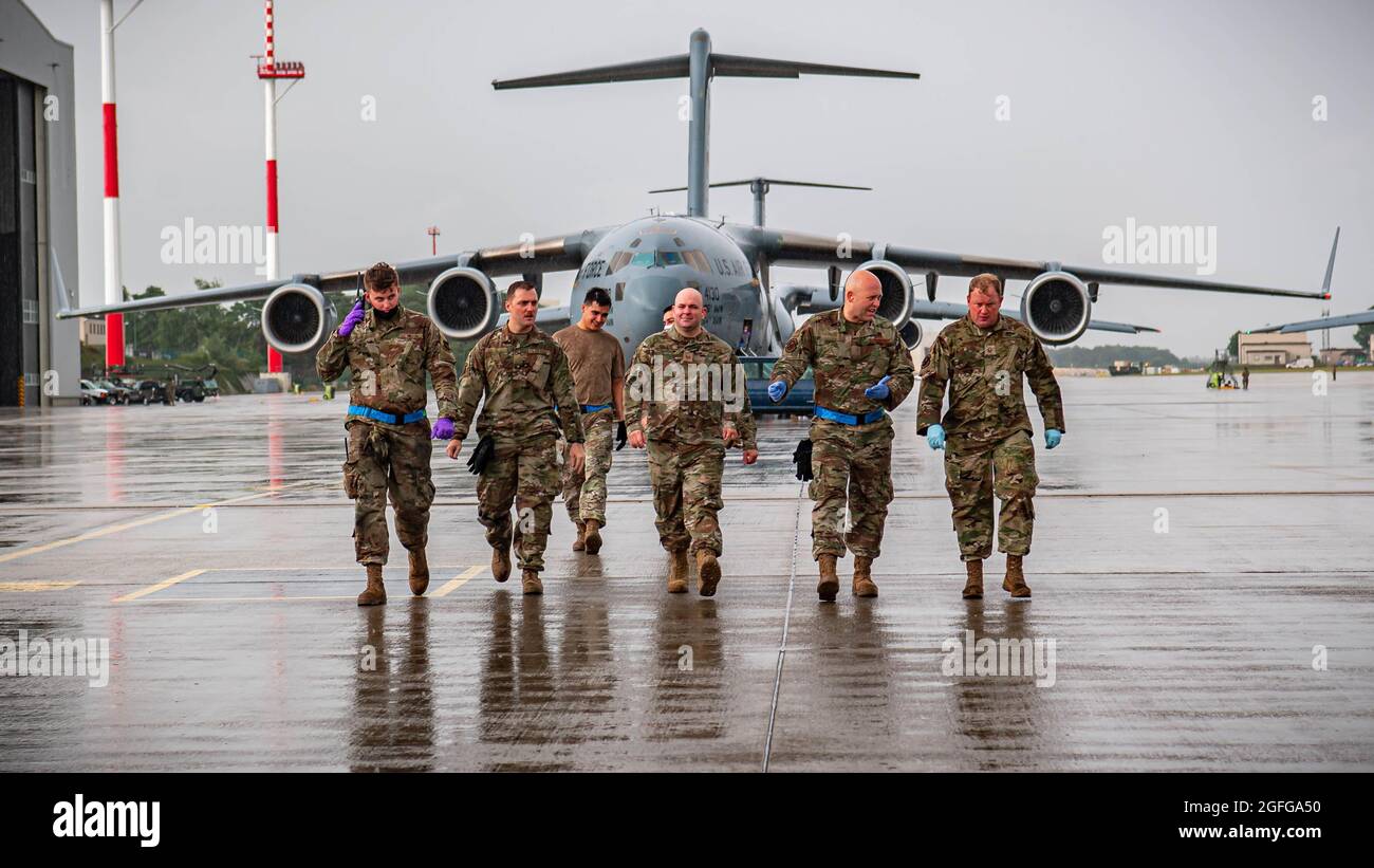 U.S. Air Force Airmen assigned to the 721st Aerial Port Squadron walk ...