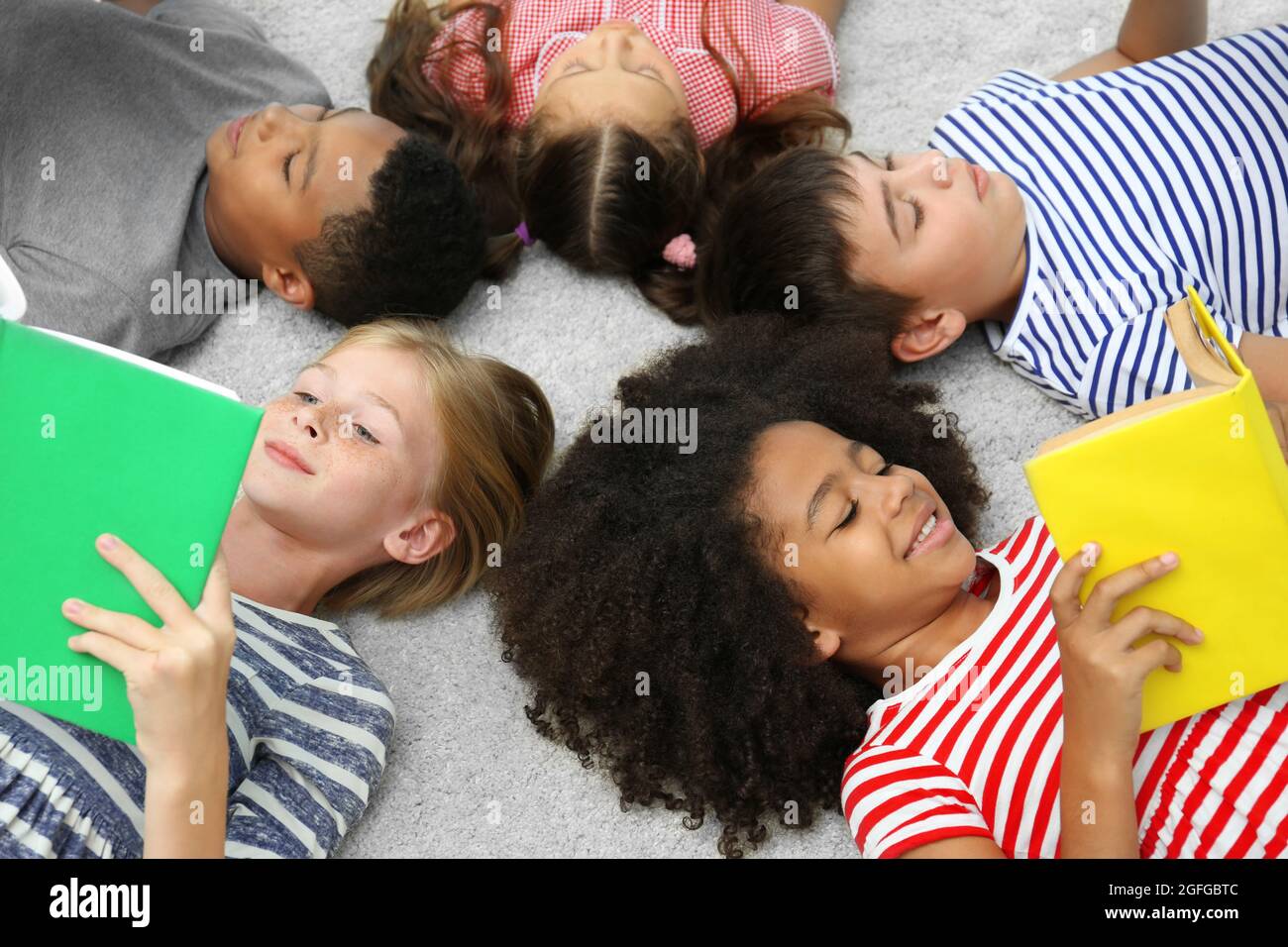 Cute kids reading books at home Stock Photo - Alamy