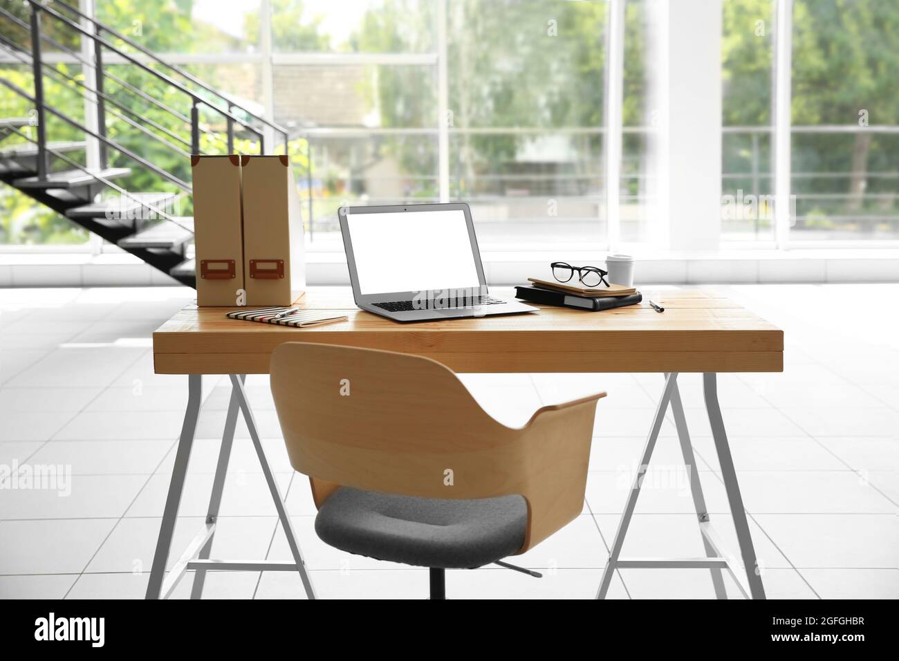Workplace with laptop in front of window Stock Photo - Alamy