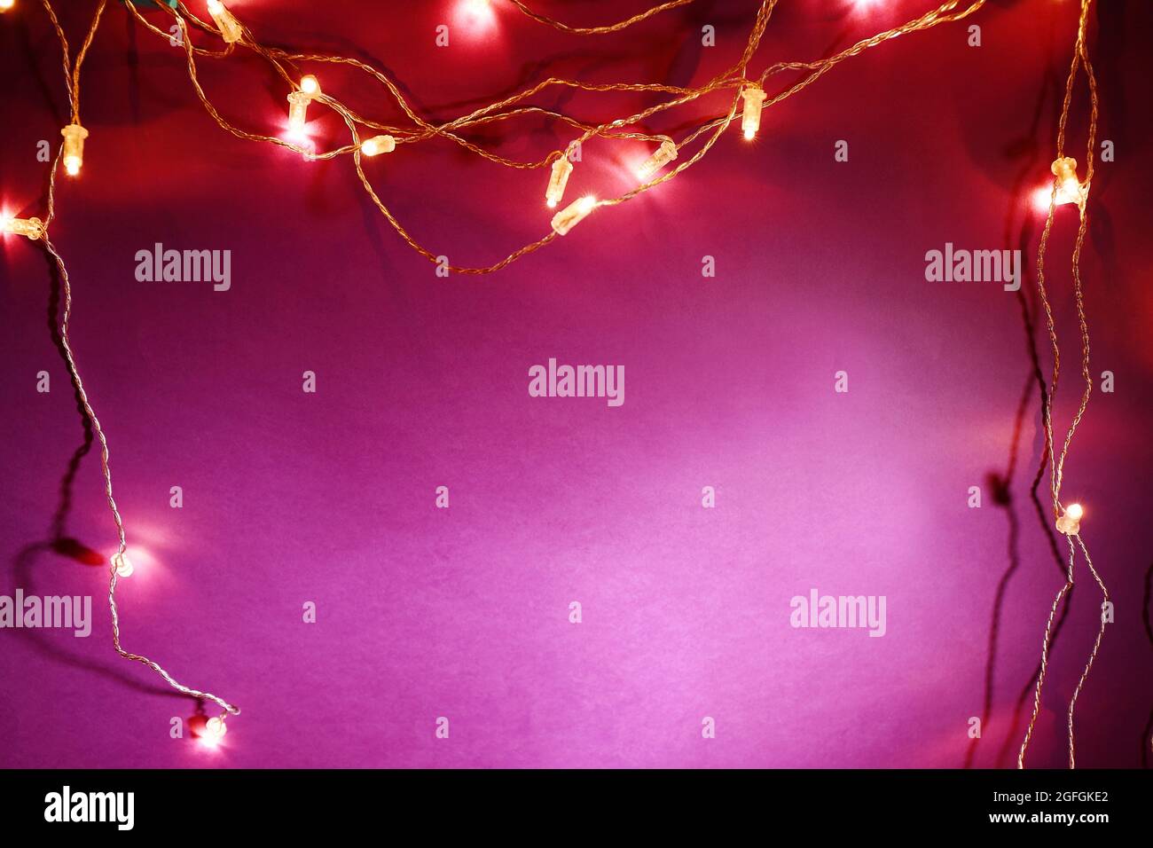 Christmas lights on color background Stock Photo - Alamy