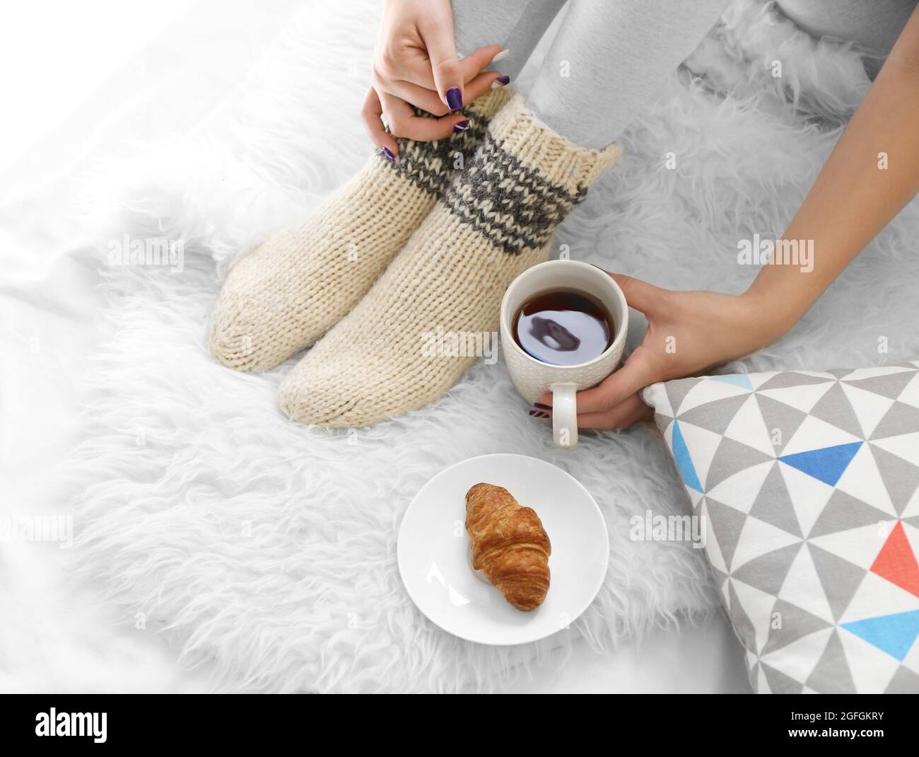 Female feet in socks with cup of tea on fluffy blanket Stock Photo - Alamy