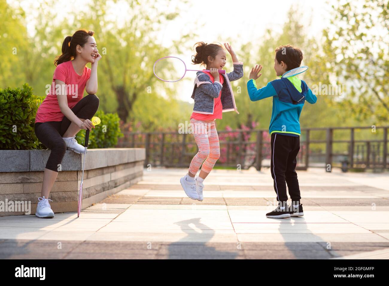 Happy young family playing badminton in park Stock Photo - Alamy