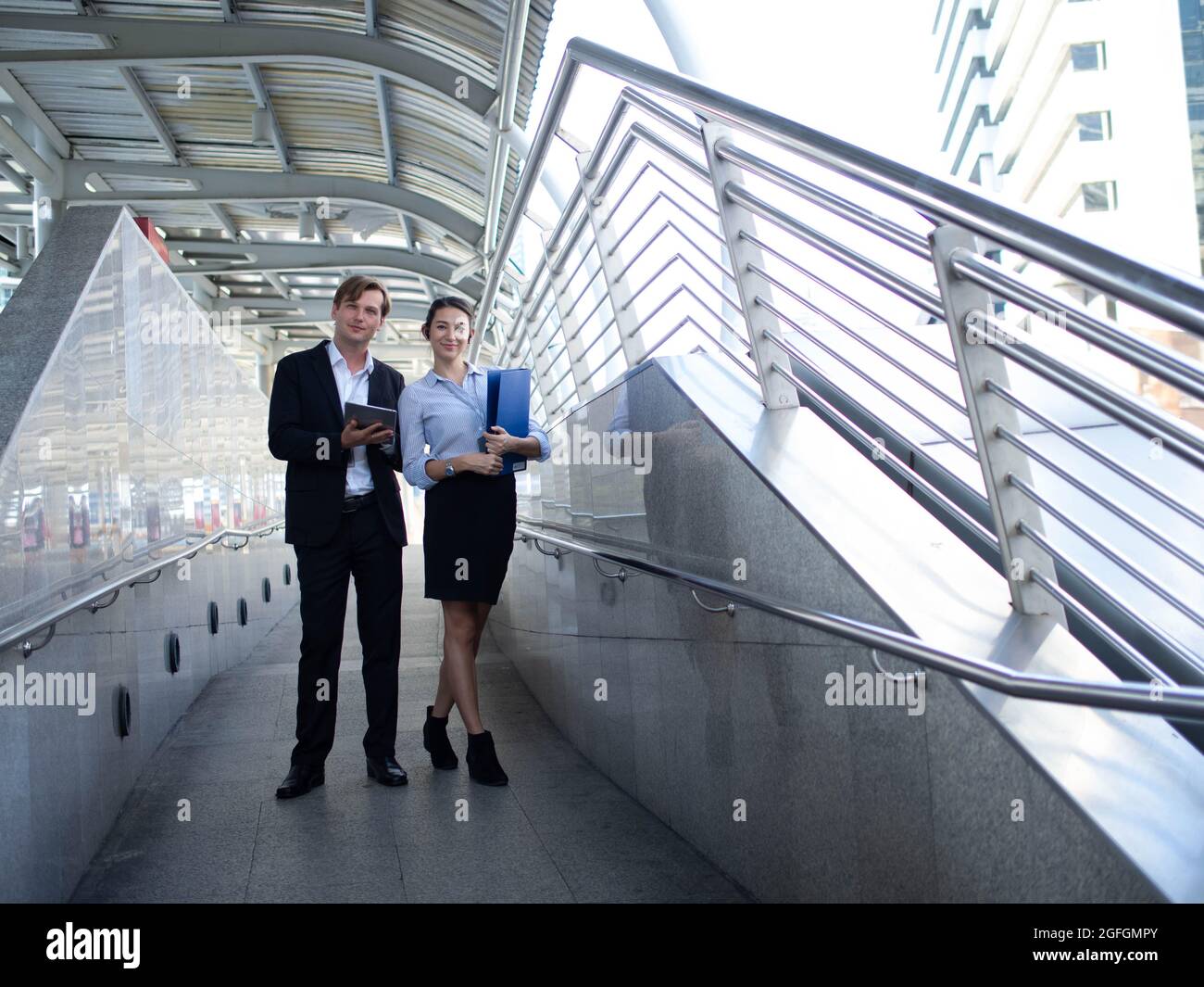 Two young successful businessmen walking hi-res stock photography and ...