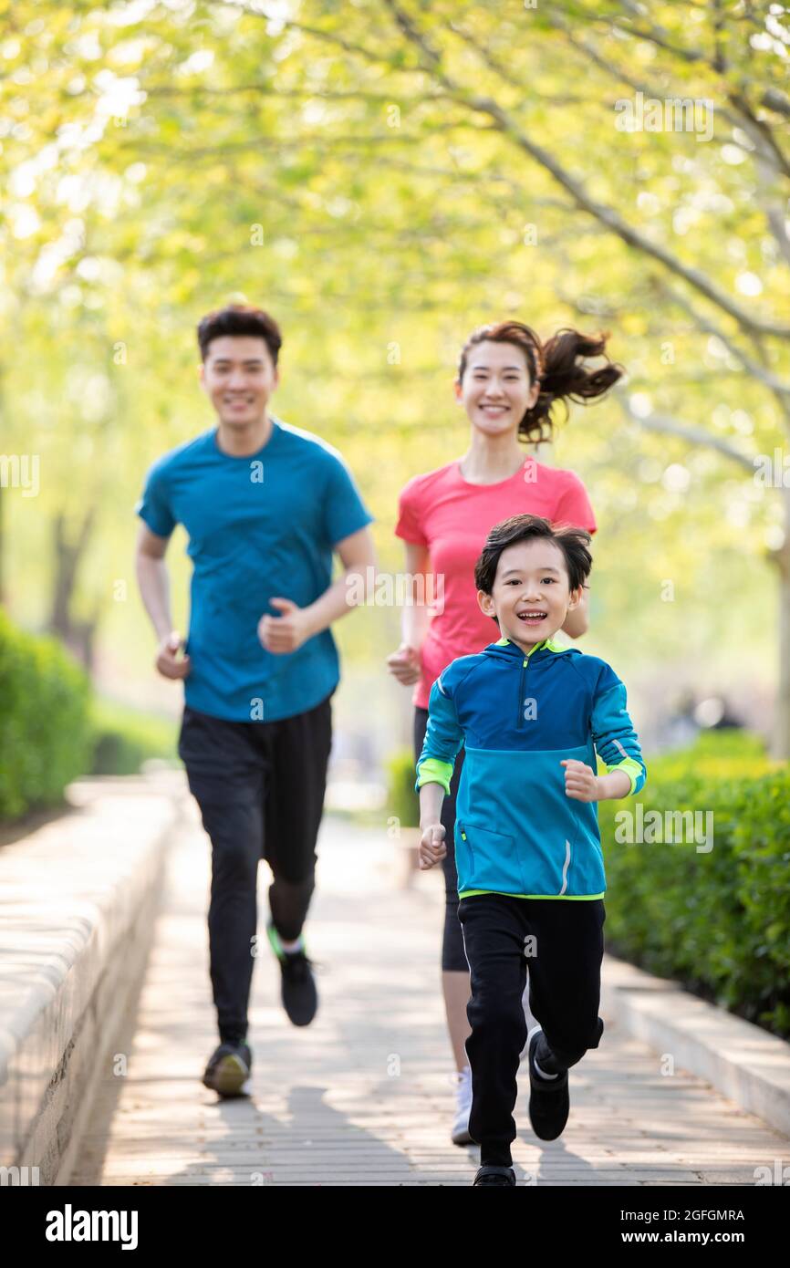Parent and son jogging in park hi-res stock photography and images - Alamy