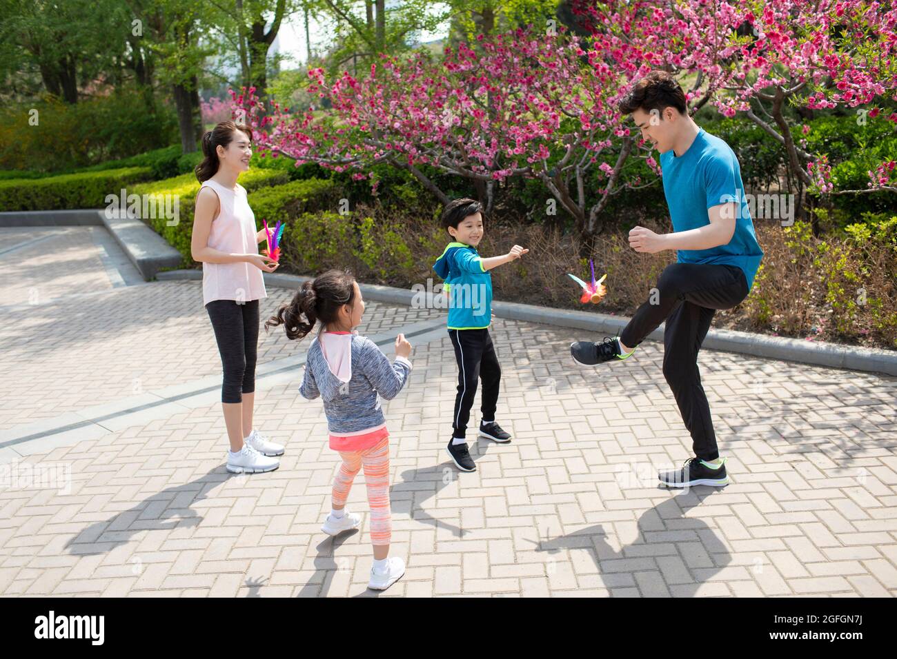 Happy young family kicking shutterlock in park Stock Photo - Alamy