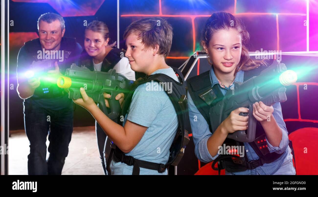 joyous teen brother and sister with laser pistols playing laser Stock ...