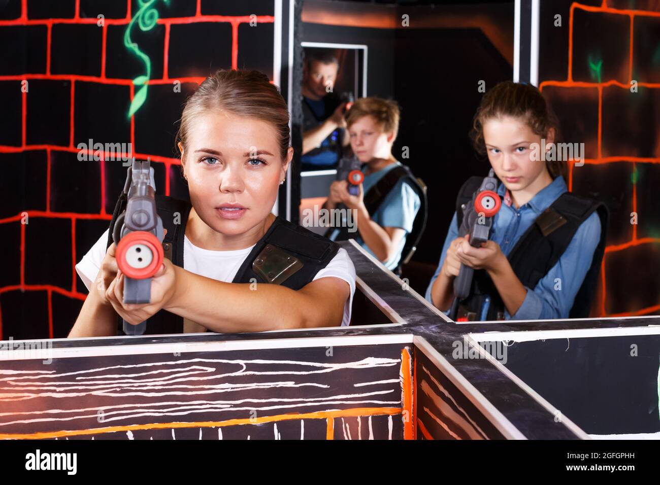 Woman playing lasertag with family Stock Photo - Alamy