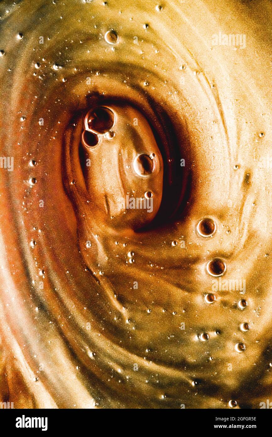 Abstract bronze liquid background, paint splash, swirl pattern and ...