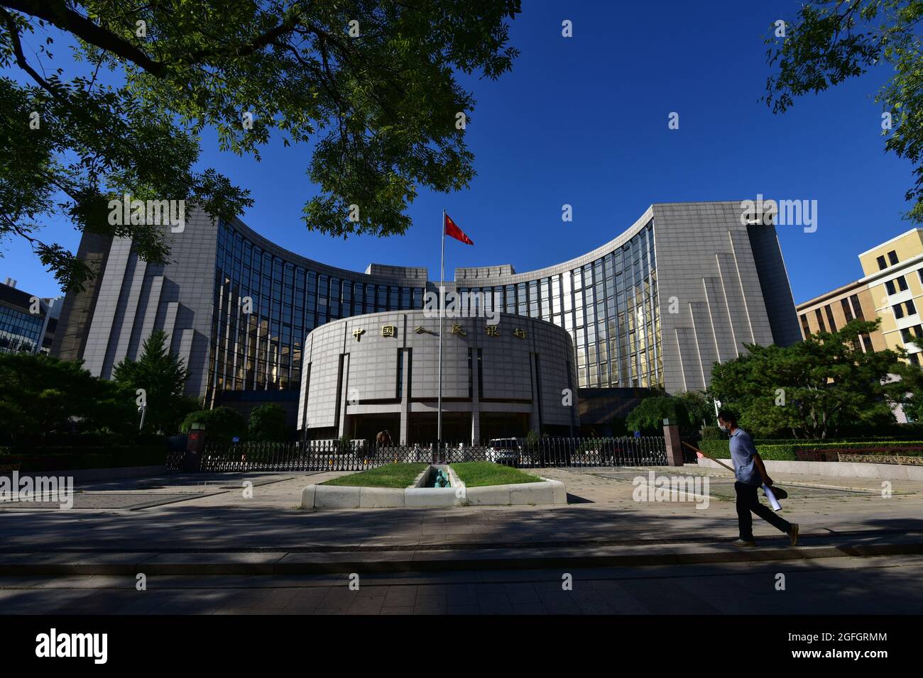 BEIJING, CHINA - AUGUST 25, 2021 - A pedestrian passes in front of the ...