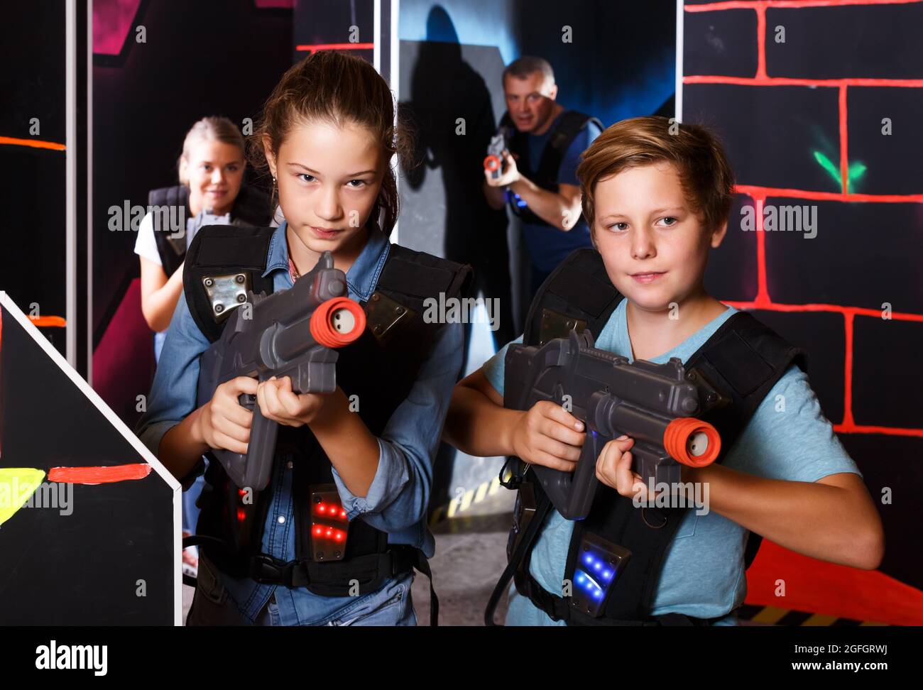 Teenage kids playing lasertag Stock Photo - Alamy