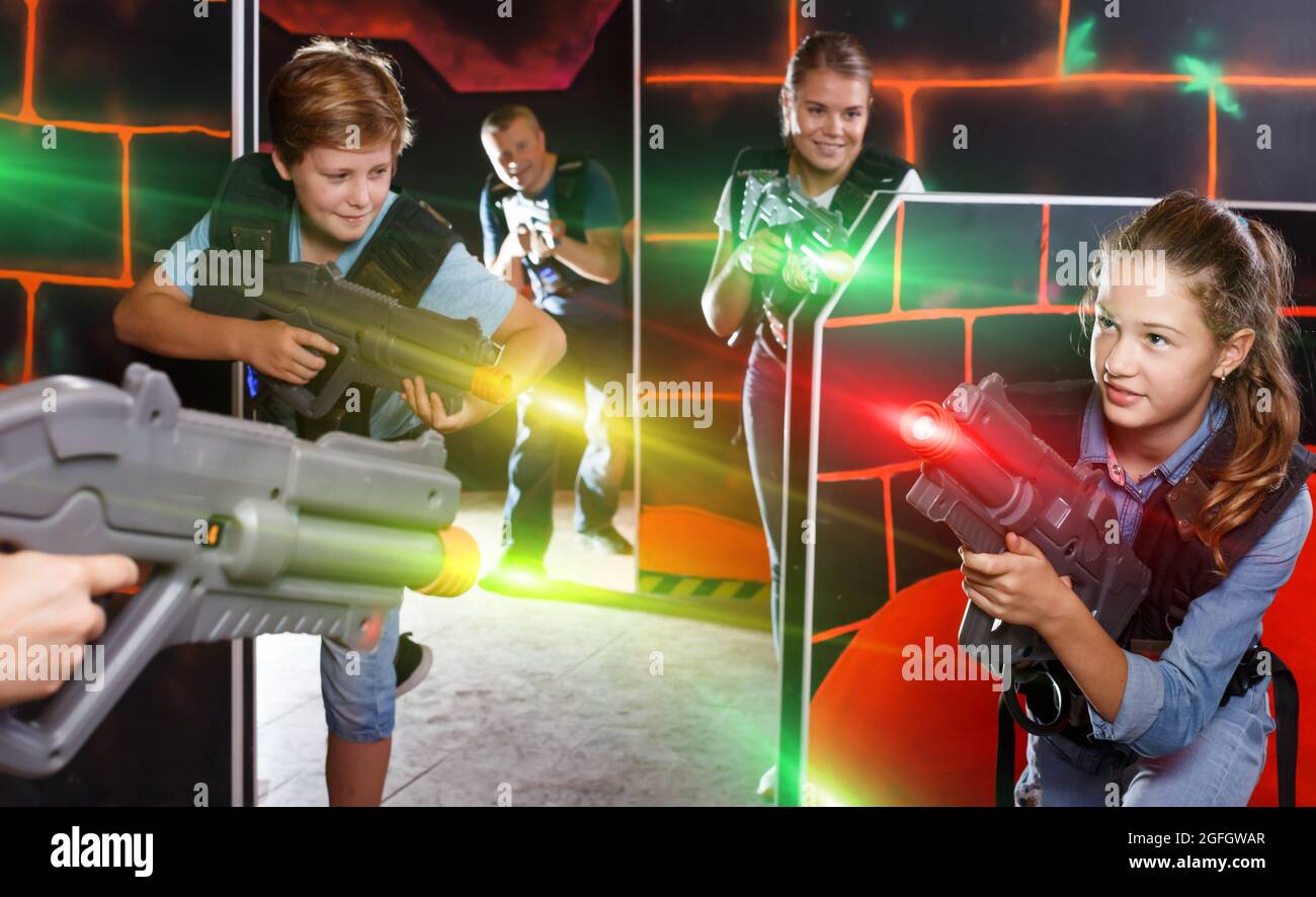 Laughing boy and girl posing with laser guns Stock Photo - Alamy