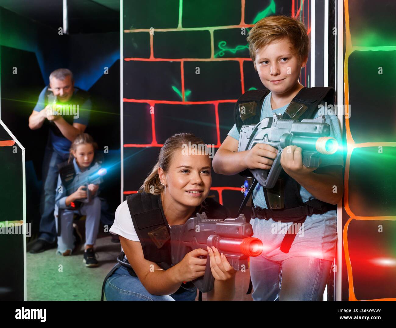 Ordinary boy and his mother aiming laser guns Stock Photo - Alamy