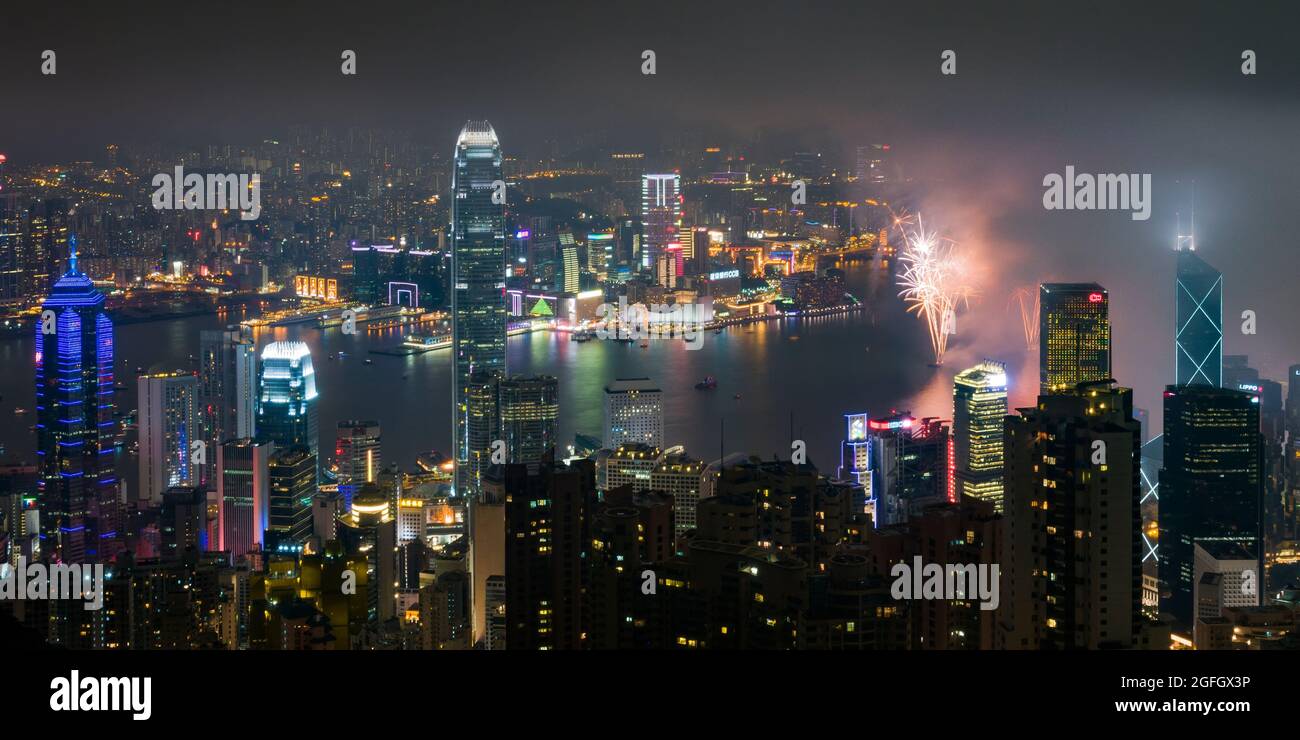The highrise of Central on Hong Kong Island and Tsim Sha Tsui, Kowloon at night with fireworks ...