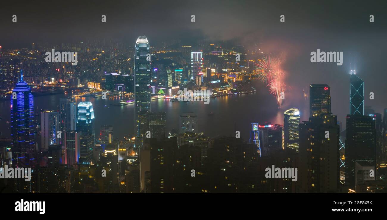 The highrise of Central on Hong Kong Island and Tsim Sha Tsui, Kowloon at night with fireworks ...