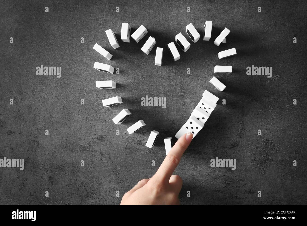 Female hand pushing dominoes on grey background Stock Photo - Alamy Female hand pushing dominoes on grey background Stock Photo - Alamy