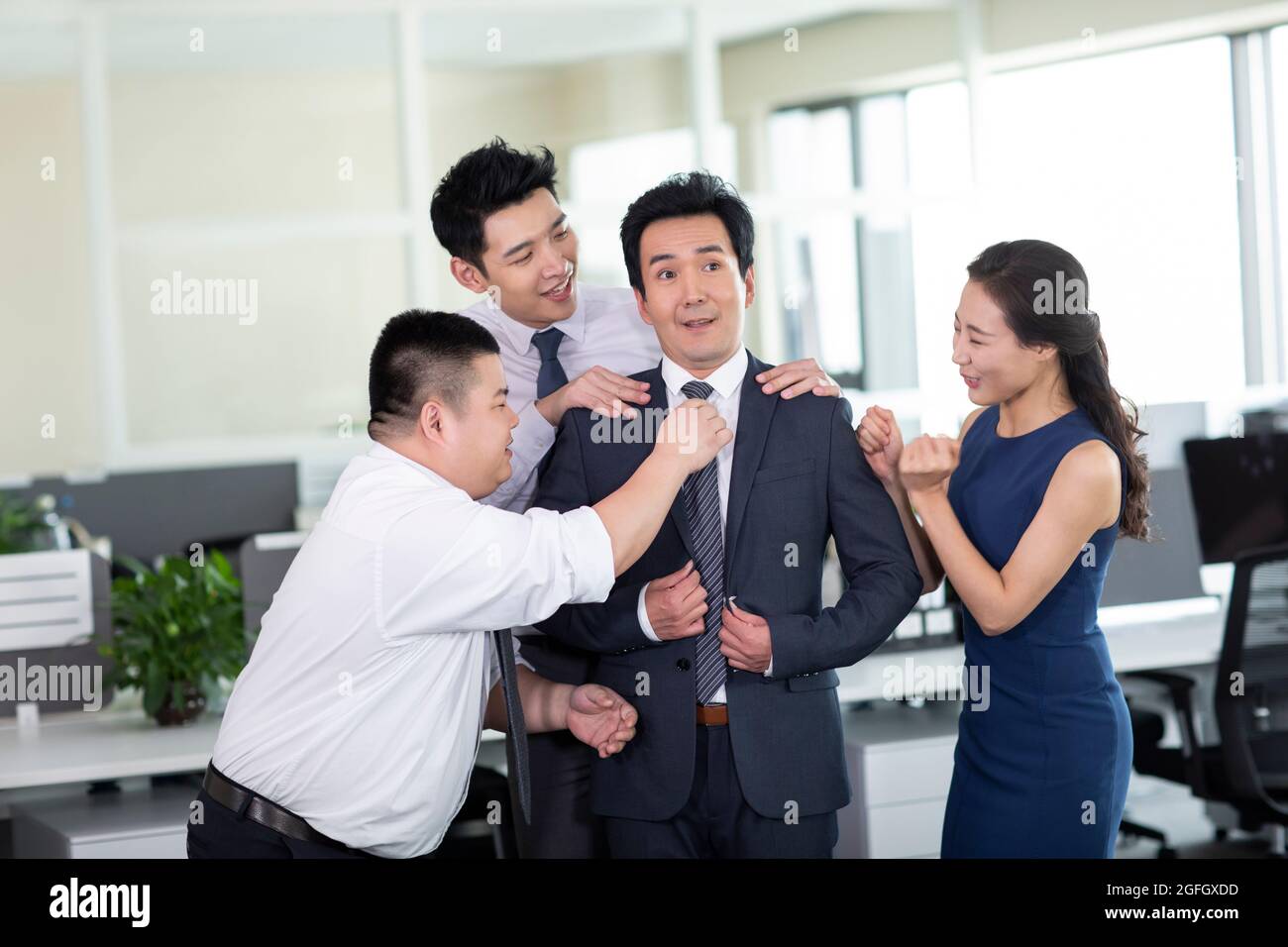 Employees flattering manager Stock Photo - Alamy