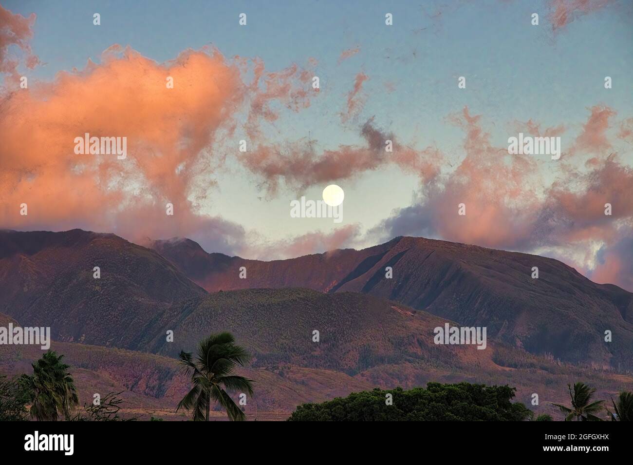 Full moon rising over the west maui mountains at sunset with pink puffy ...