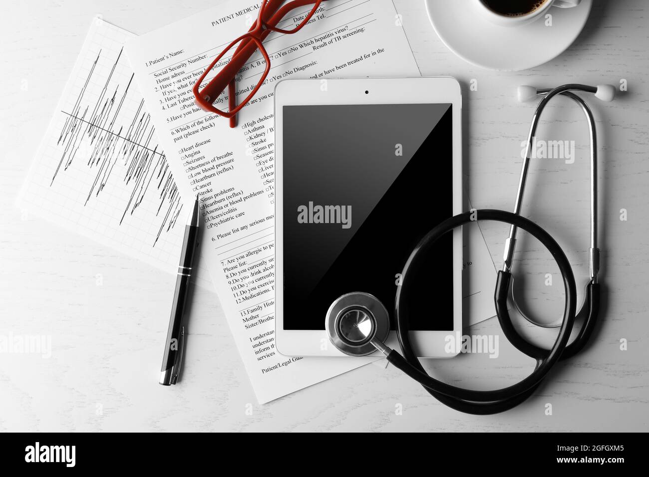 Medical reports and tablet on white wooden background Stock Photo - Alamy