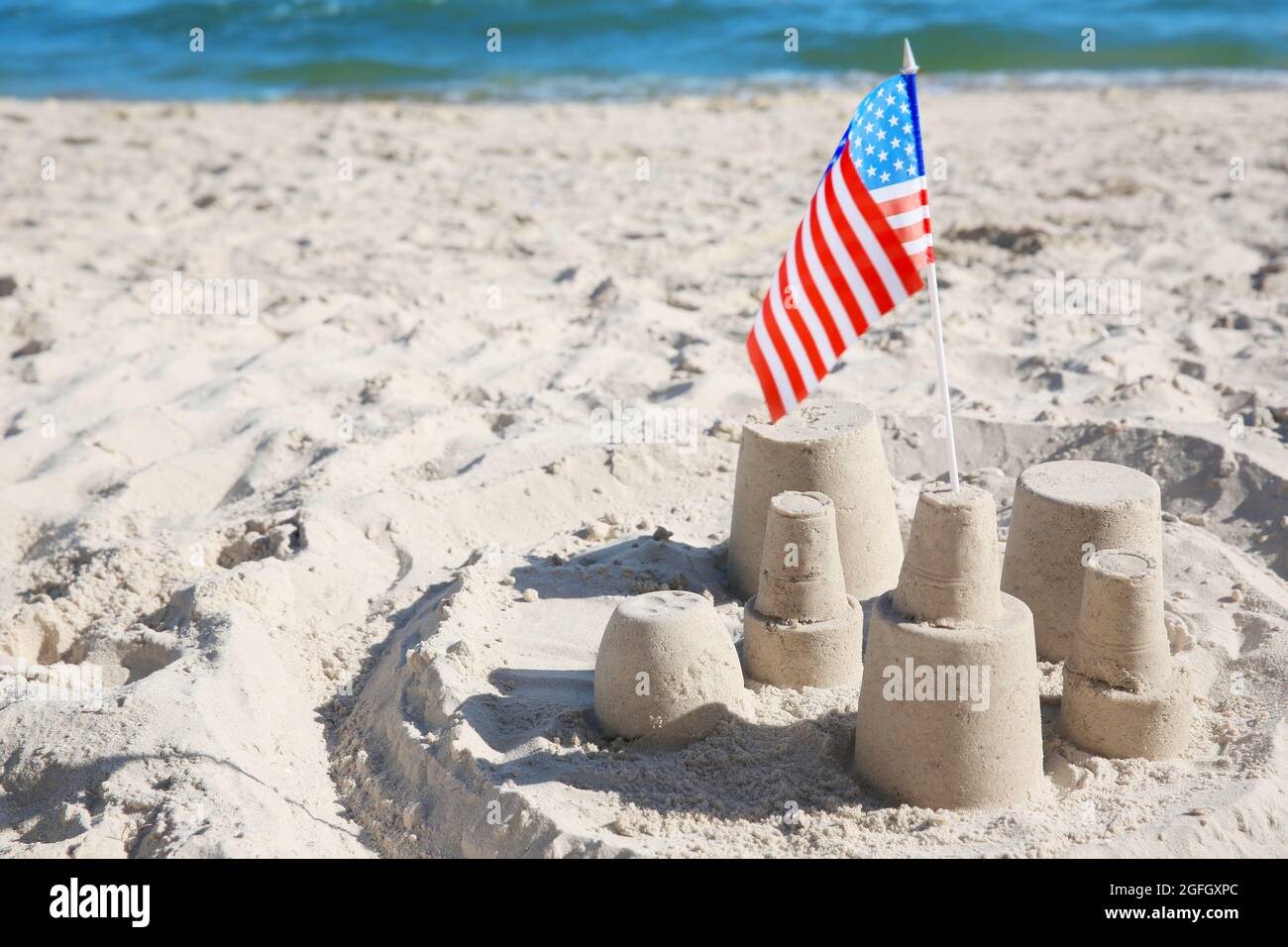 Sand castle with American flag on beach Stock Photo - Alamy
