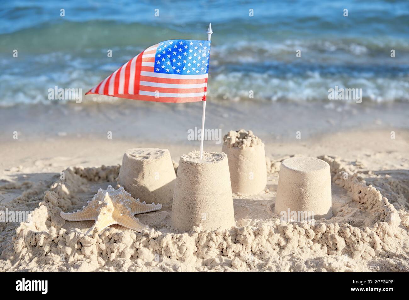 Sand castle with American flag on beach Stock Photo - Alamy