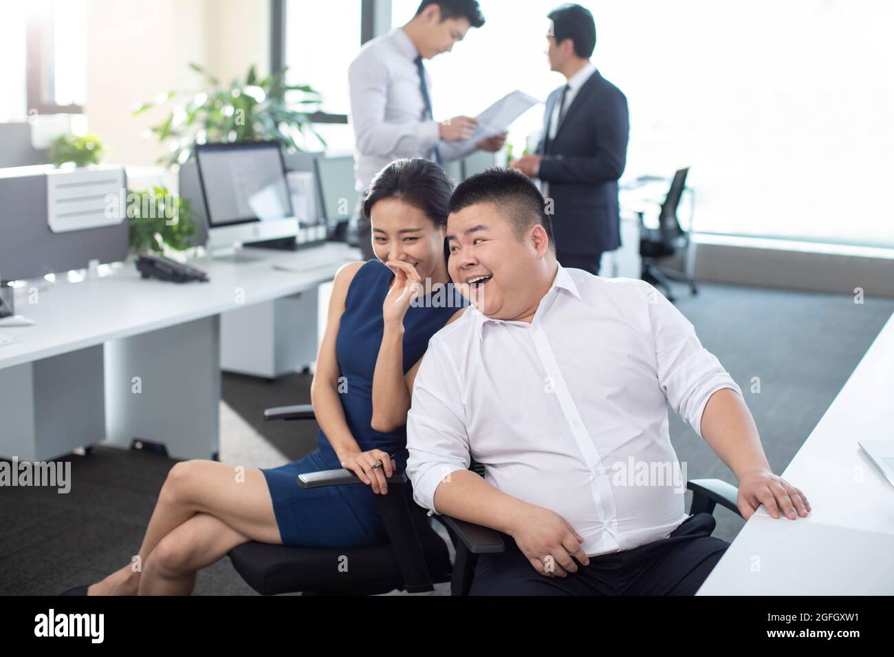 Business people talking gossip in office Stock Photo - Alamy
