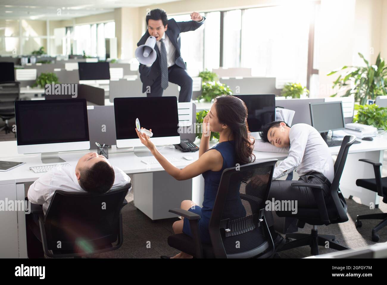 Angry manager yelling at employees through megaphone in office Stock ...
